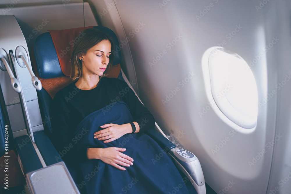 Traveling at first class. Flight with comfort. Pretty young woman ...