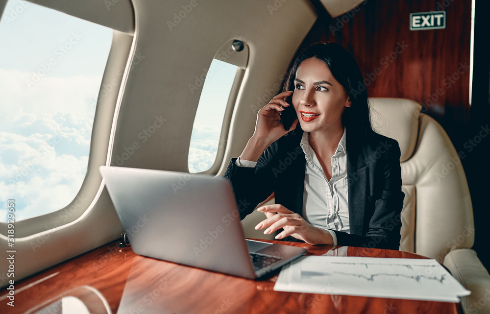 Business woman in private jet Stock Photo | Adobe Stock