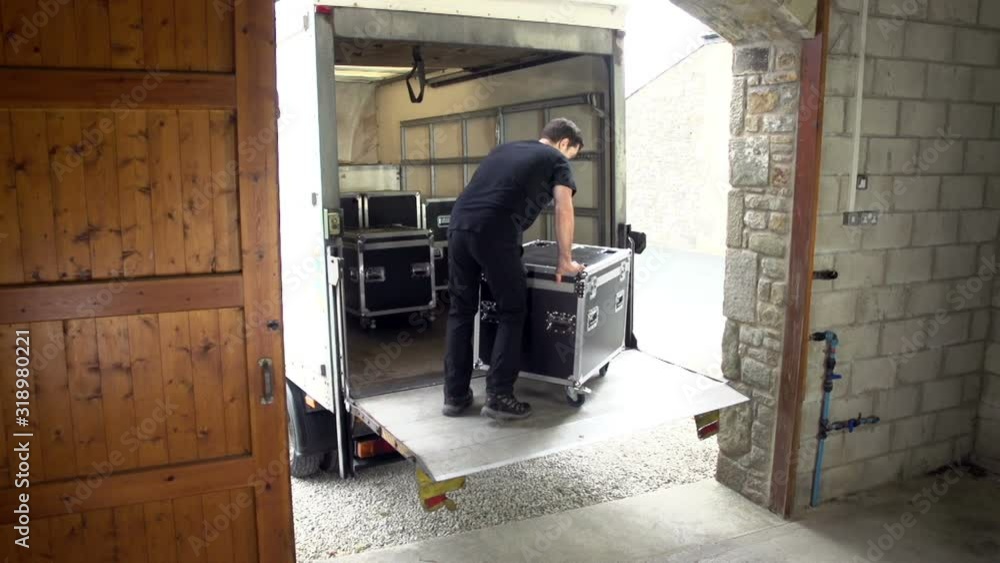 Roadie / Stage Crew unloading Flightcase Trunk from the Truck for a Gig ...