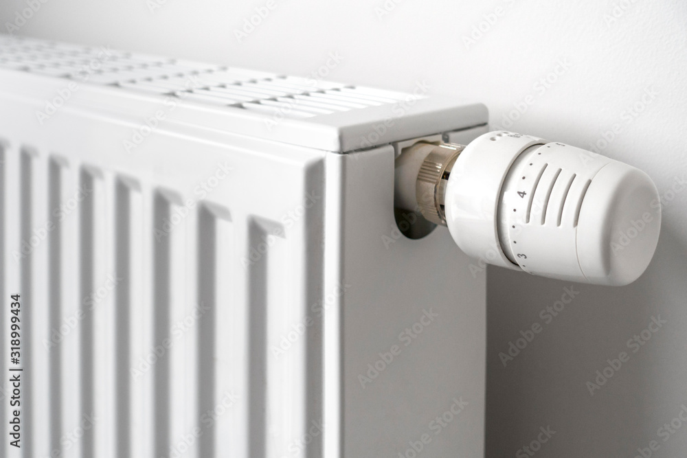 Close-up of thermostatic radiator valve / TVR fitted to household hot ...