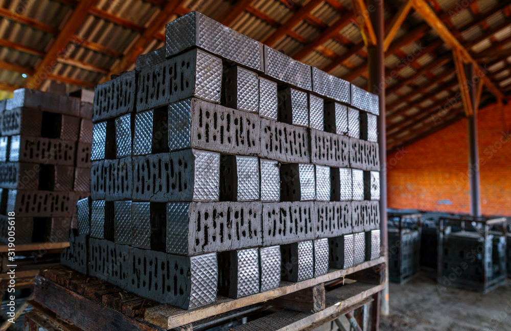 Production of clay bricks at a brick factory. Molded bricks stacked on ...