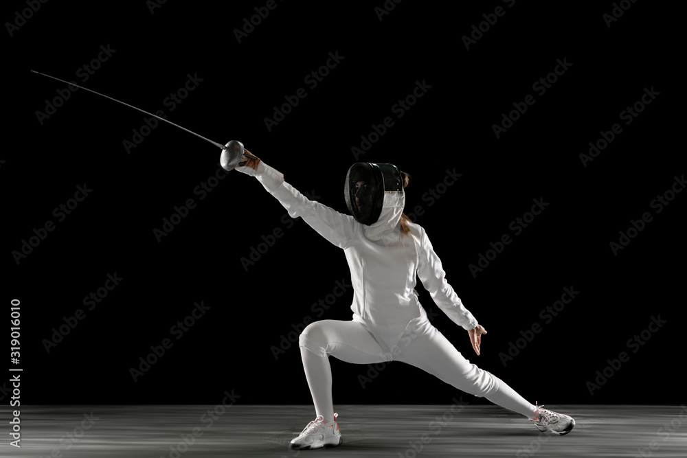 Targets. Teen girl in fencing costume with sword in hand isolated on ...