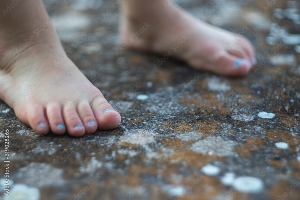 little girl barefoot in summer on limestone Stock Photo | Adobe Stock