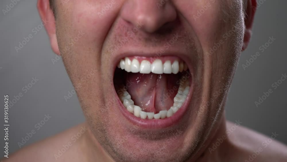 Man with angry facial expression is screaming out loud. Portrait of a ...