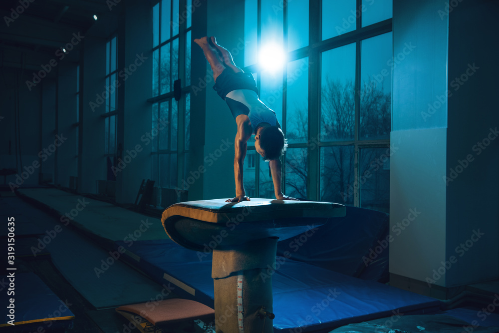 Little male gymnast training in gym, flexible and active. Caucasian fit ...