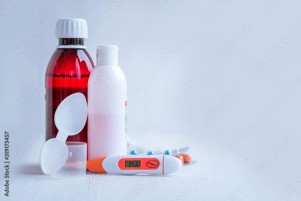 Orange thermometer and pills. Body temperature measurement. Normal ...