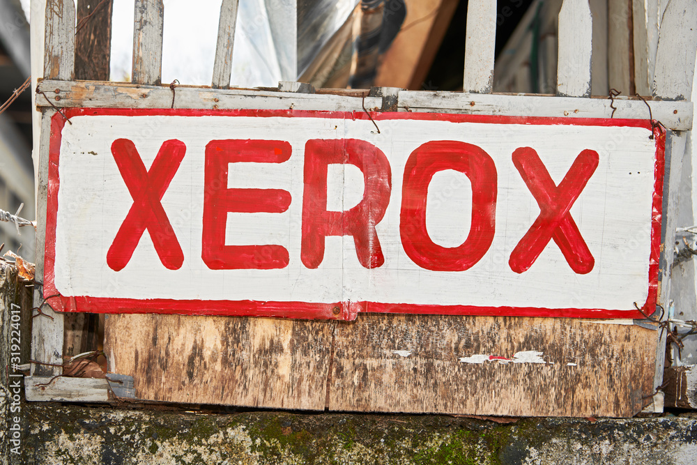 Hand-painted Xerox signage on plywood, informing the people that a copy ...