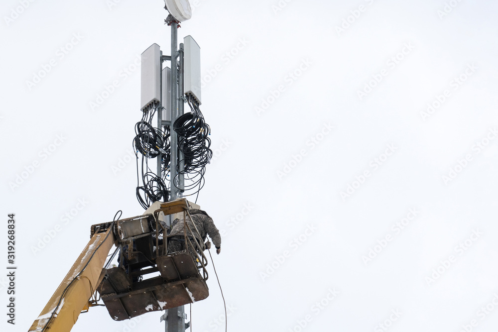 Installation of equipment on a cellular mast. The installer sets the ...