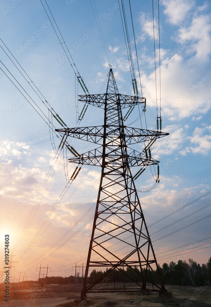 High-voltage power lines at sunset or sunrise. High voltage electric ...