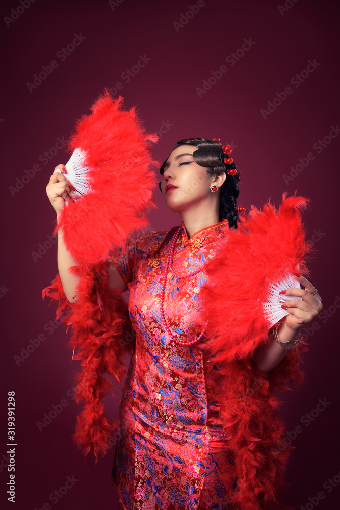 Beautiful chinese woman wearing traditional red dress holding fans up ...