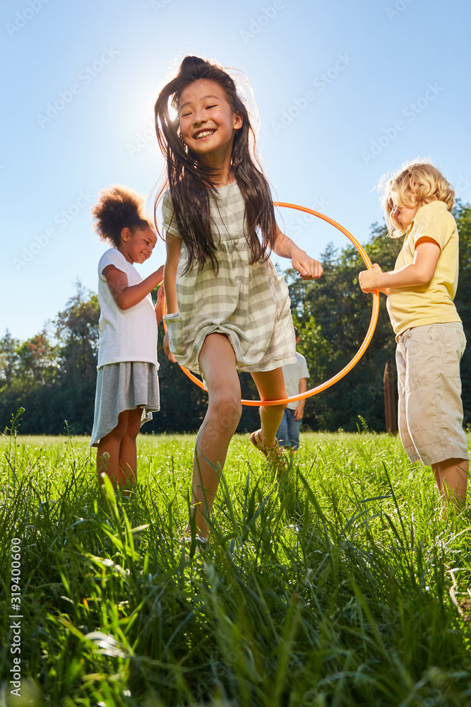 Girl jumps through a hoop as a sport Stock Photo | Adobe Stock