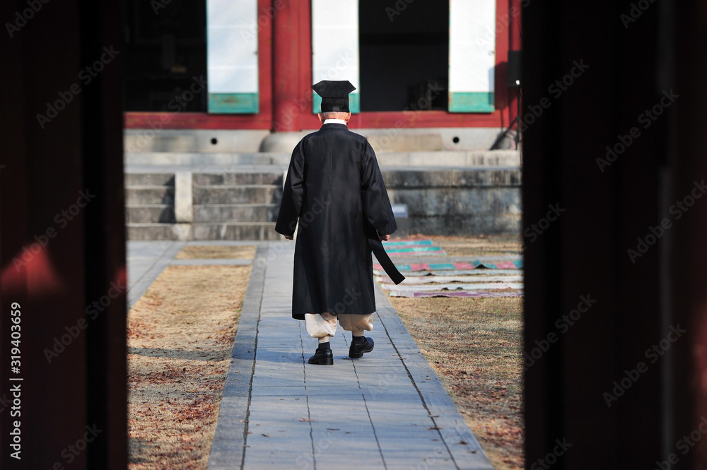 A confucian scholar is walking in korean traditional clothing at Jeonju ...