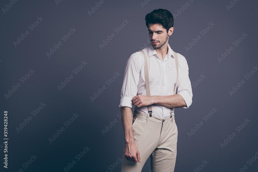 Portrait of serious imposing man correct his adjust sleeves look ...