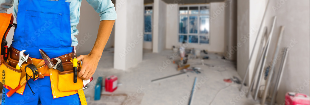 Builder handyman with construction tools. House renovation background ...