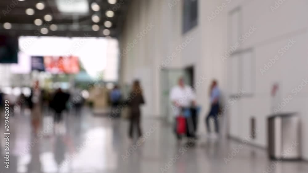 Blurred crowd of people passing by in hallway during trade fair Stock ...