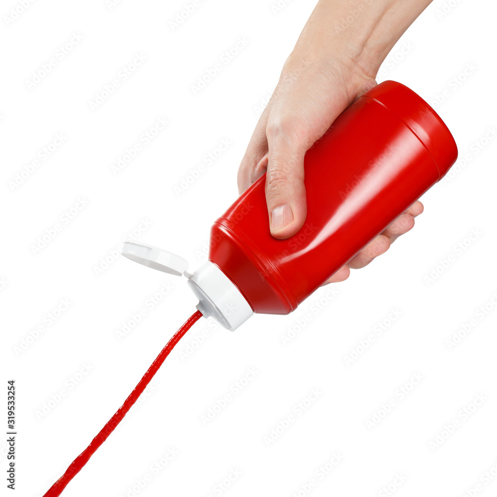 Hand squeezing ketchup out of a plastic bottle, isolated on white ...