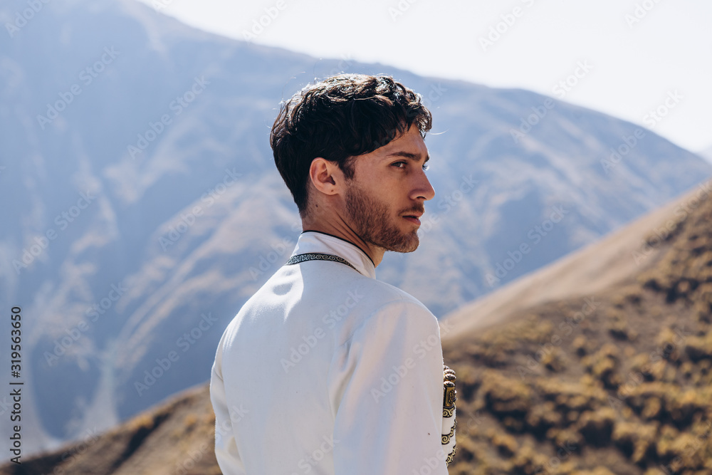 noise effect, selective focus: stylish Georgian man dressed in white ...