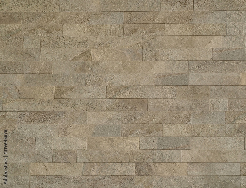 Elegant cladding wall made of natural stone bricks. Color is brown with ...