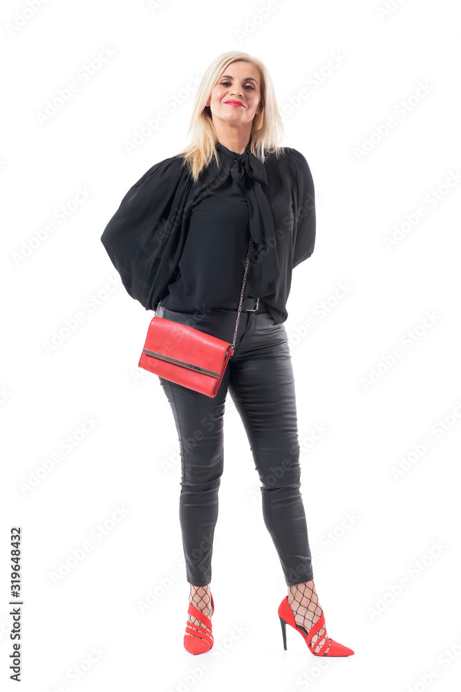 Confident elegant middle aged woman posing in black blouse, leather ...
