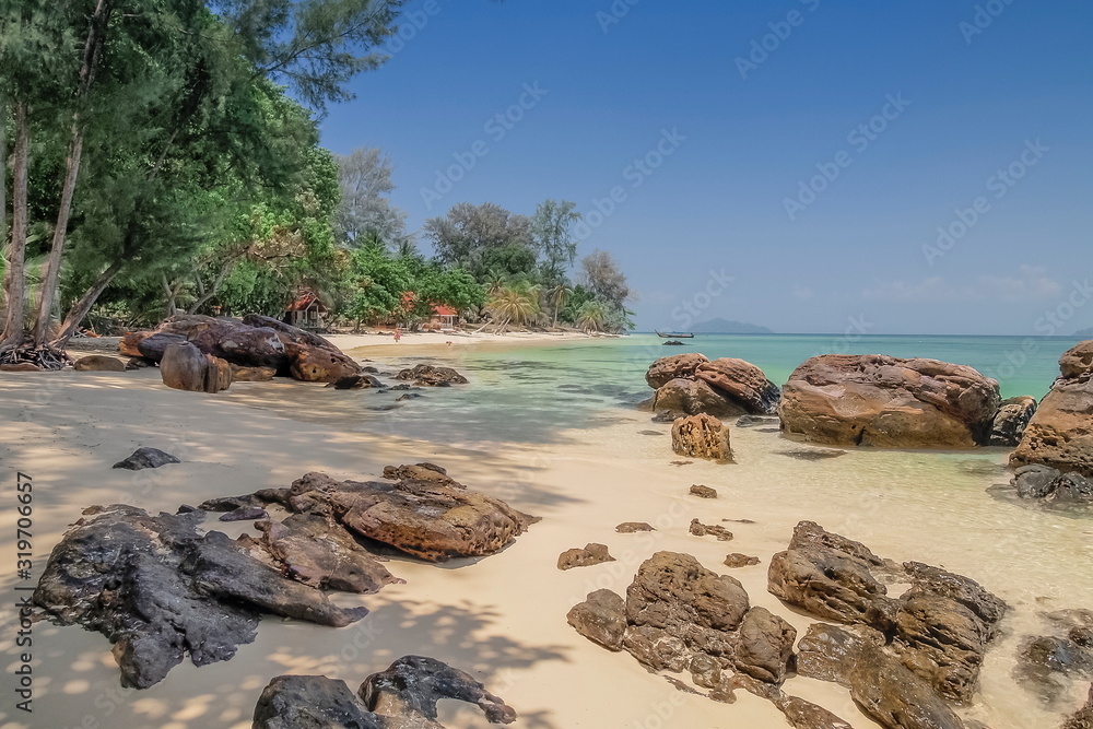 view seaside of many arch rocks on white sand beach with blue-green sea ...