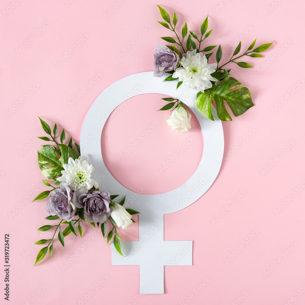 Gender symbol with flowers and leaves on pink background. Venus or ...