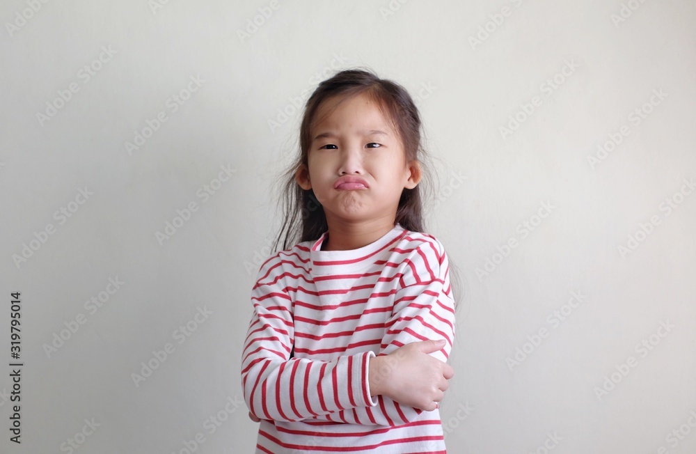 Cute Sad Girl Sulking While Making Face Against White Wall Stock Photo ...