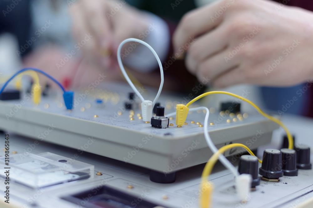 Engineering students working in the lab. Students are adjusting an ...