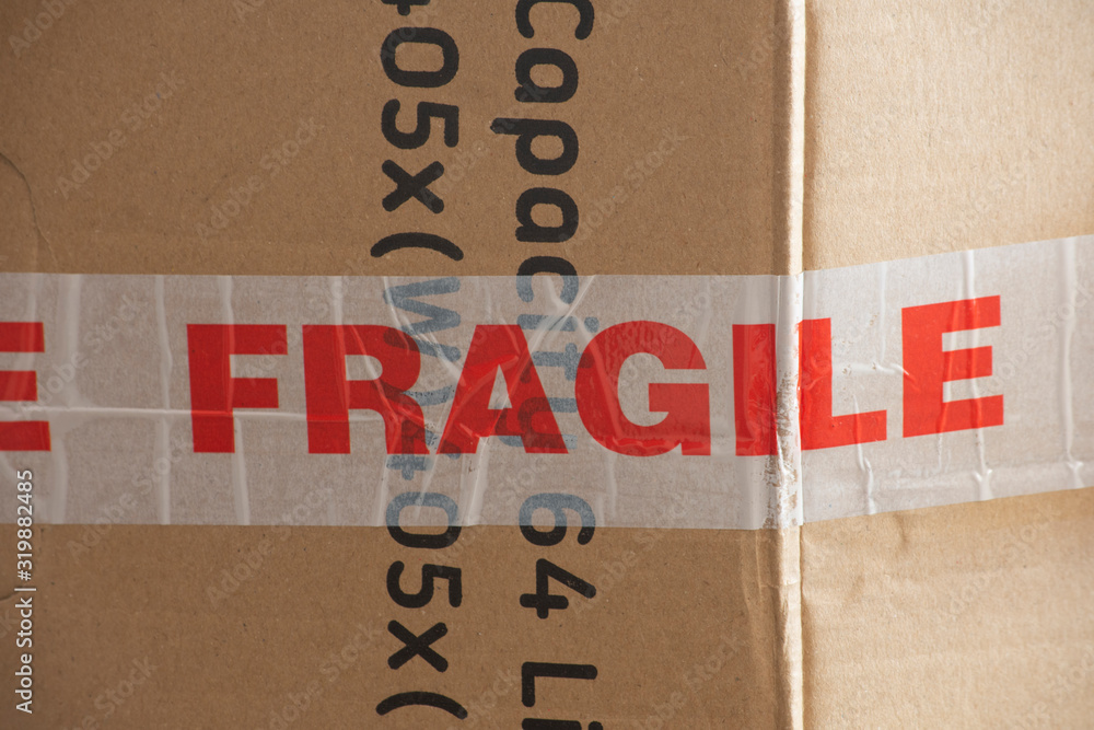 Fragile warning sticker on cardboard box Stock Photo | Adobe Stock