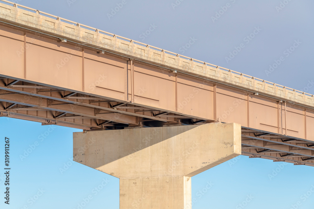 View beneath a stringer bridge with massive abutment that supports the ...