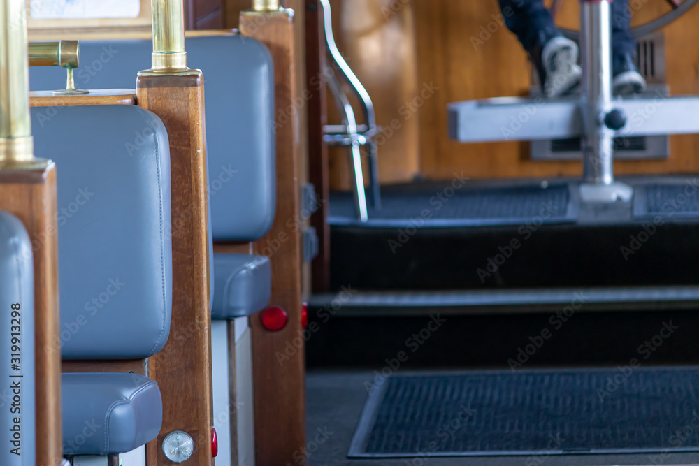 interior seating of old wooden ferry boat with seating and captains ...