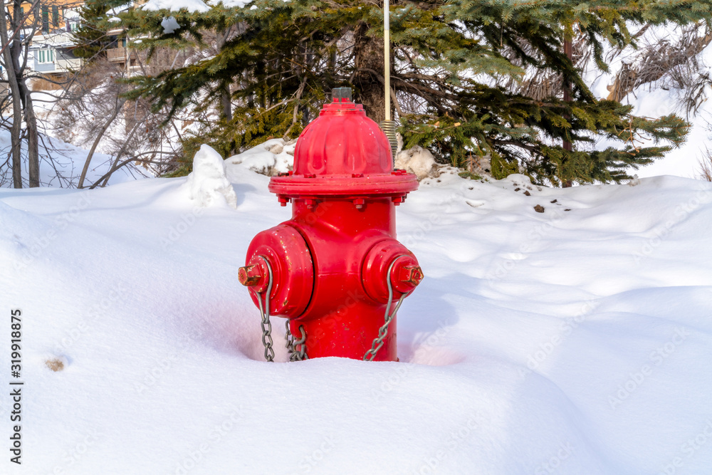 Vibrant red fire hydrant against fresh snow during winter in Park City ...