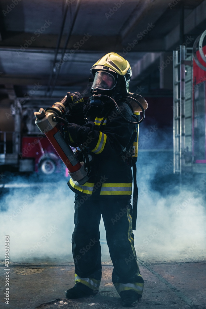 Portrait of a female firefighter wearing a helmet and all safety ...
