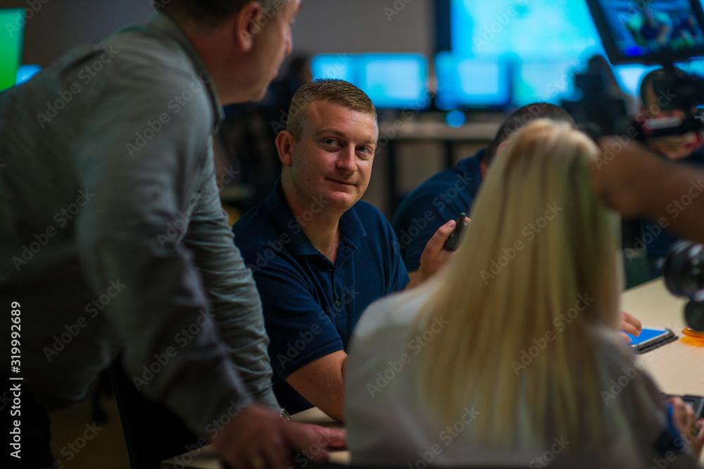 Security guard monitoring modern CCTV cameras in a surveillance room ...