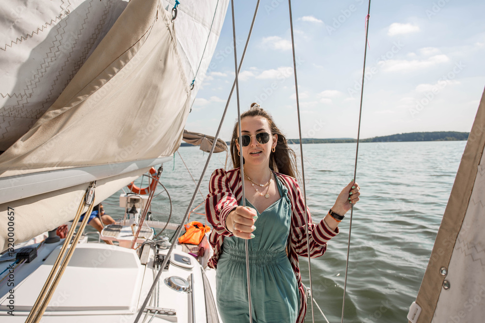 Girl staying on the sailboat. Woman in nice outfit and sunglasses ...