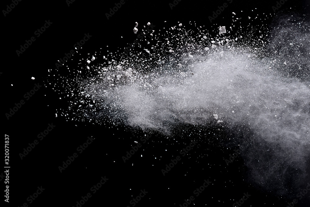 Freeze motion of white color powder exploding on dark background. Stock ...