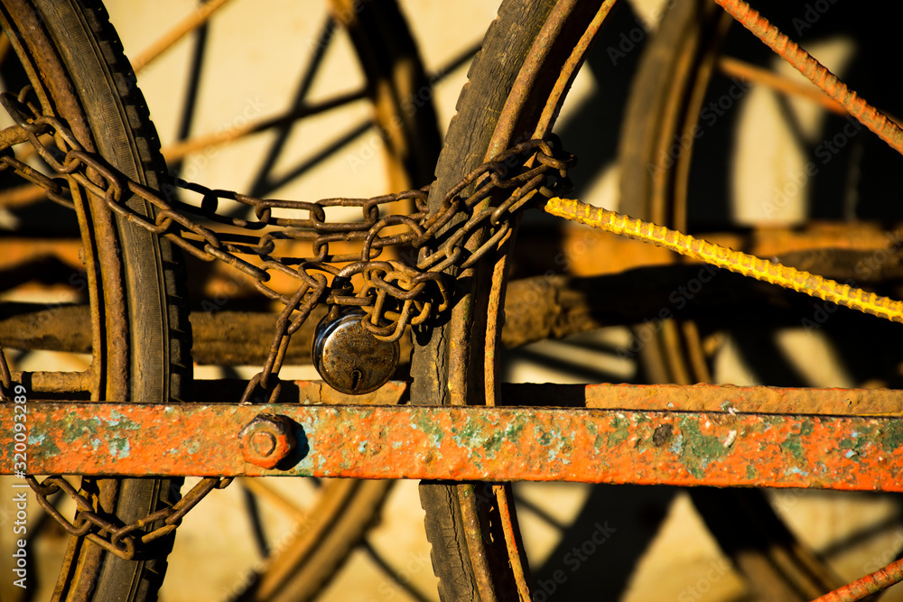 Photograph of hand cart wheels chained with a lock between the wheels ...