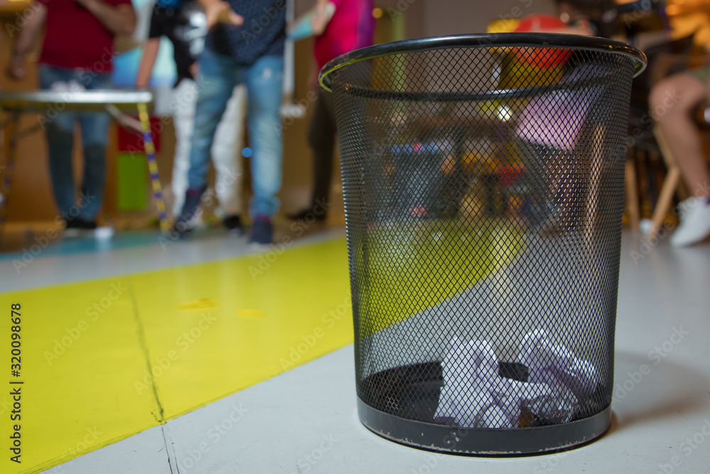 Male hand throwing crumpled paper into metal trashcan . School and ...