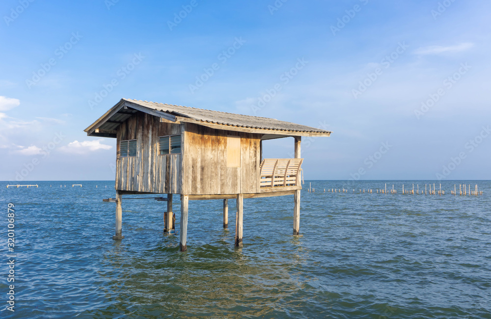 Wooden timber houses on stilts in water sea with clear blue sky near ...