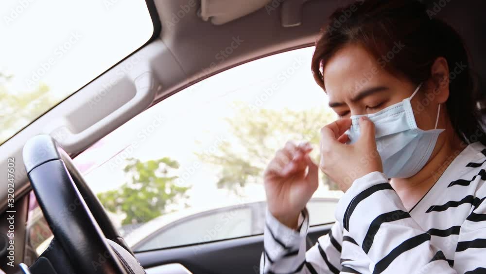 Stressed asian woman with protection masks of many layers,worried about ...