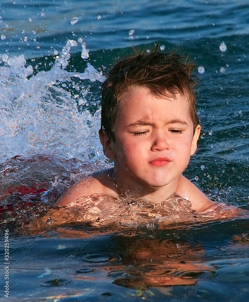 Little boy trying to swim for first time during Summer vacation in ...