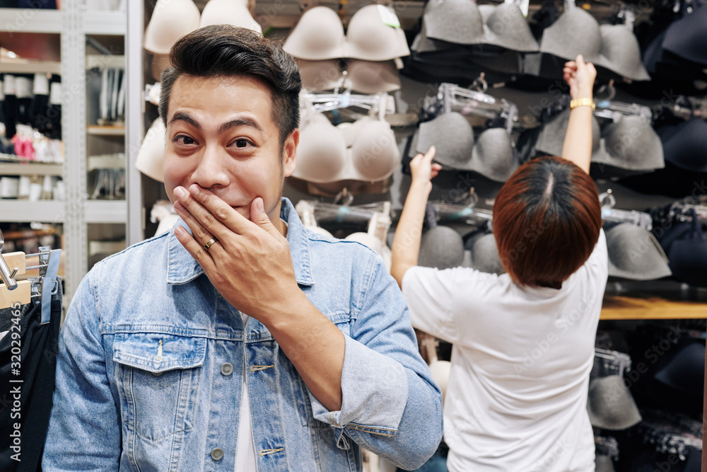 Horizontal portrait shot of shy Asian man waiting for his girlfriend ...