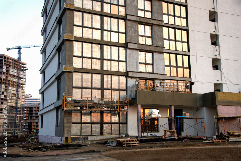 Suspended construction cradle on the background facade of the building ...