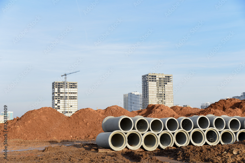 Concrete drainage pipes at the construction site. Laying of underground ...