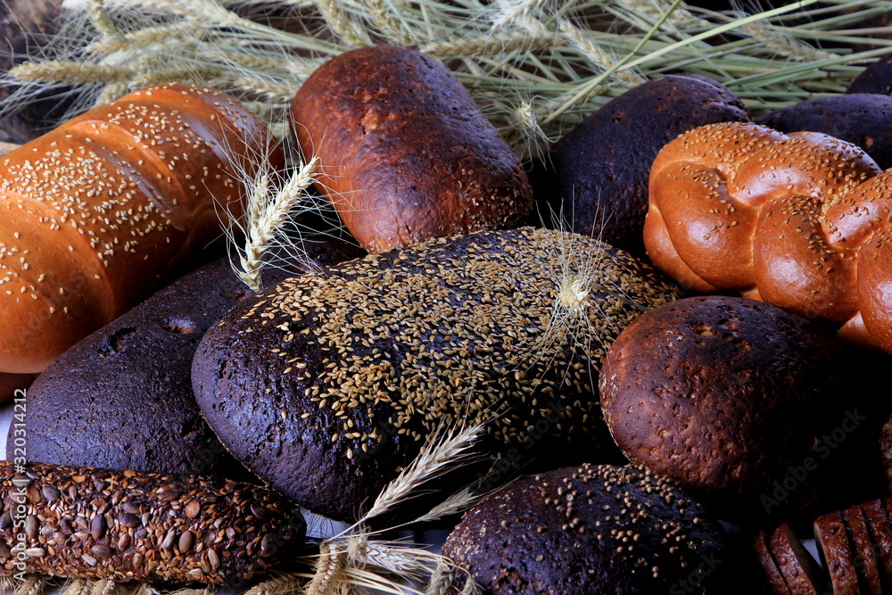 Fresh collection of bread and wheat on the table. Collection of ...