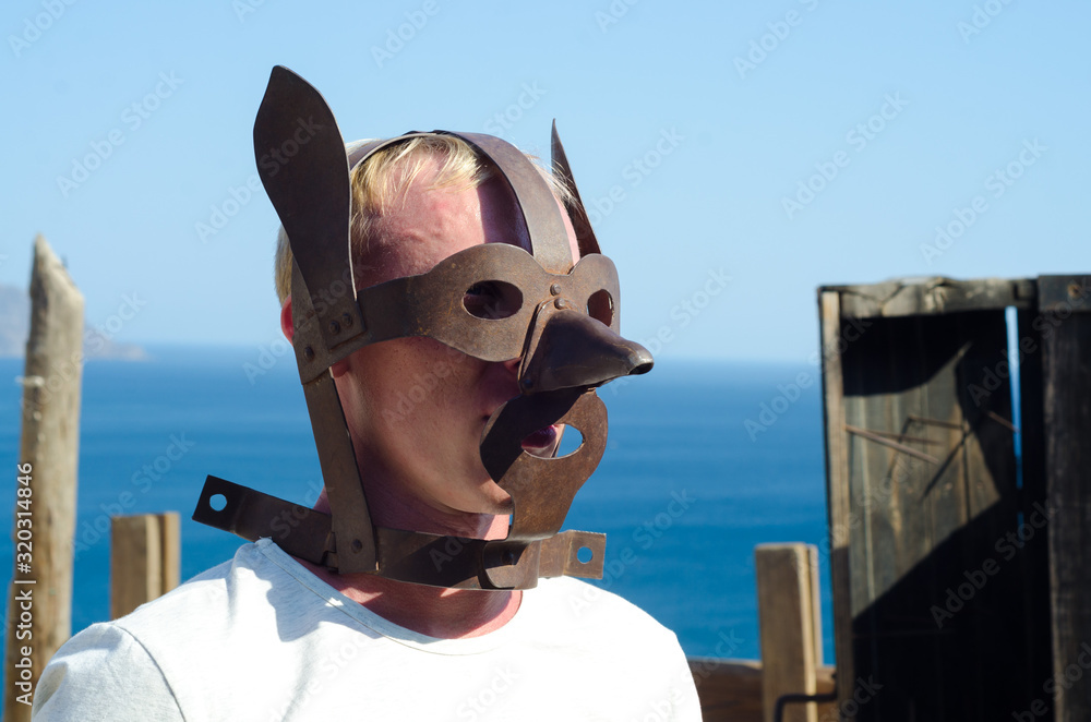 medieval torture mask on blond man Stock Photo | Adobe Stock