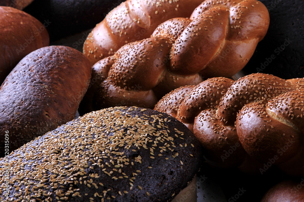 Fresh collection of bread and wheat on the table. Collection of ...