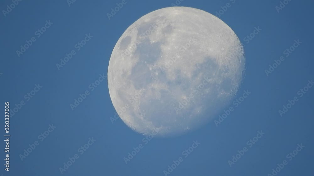 Twilight near full moon moving across the late afternoon sky before ...
