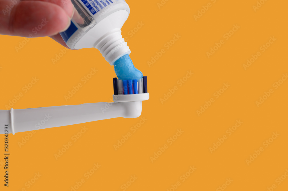 Blue gel toothpaste squeezed onto an battery cell operated electric ...