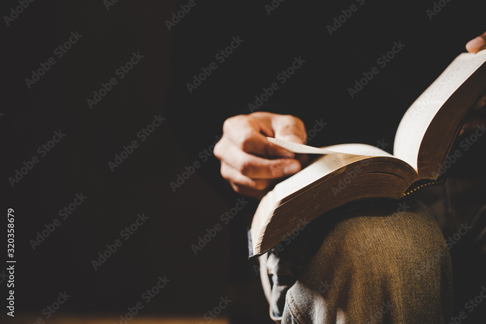 a christian man reading the bible. Stock Photo | Adobe Stock
