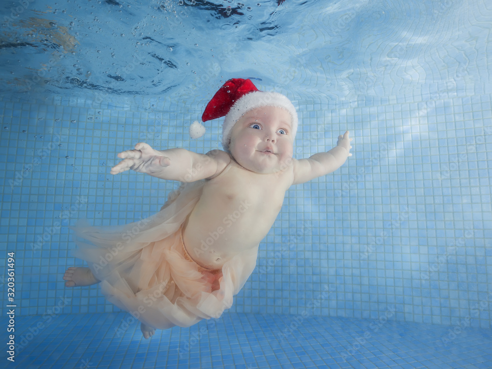 Cute chubby little girl dives underwater in a swimming pool Stock Photo ...